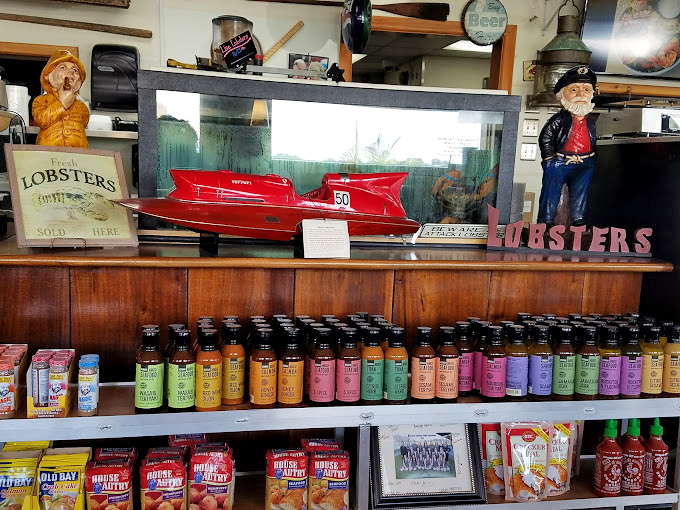Hot sauces lined up like soldiers ready for duty, because sometimes even perfect seafood needs a little kick of personality.