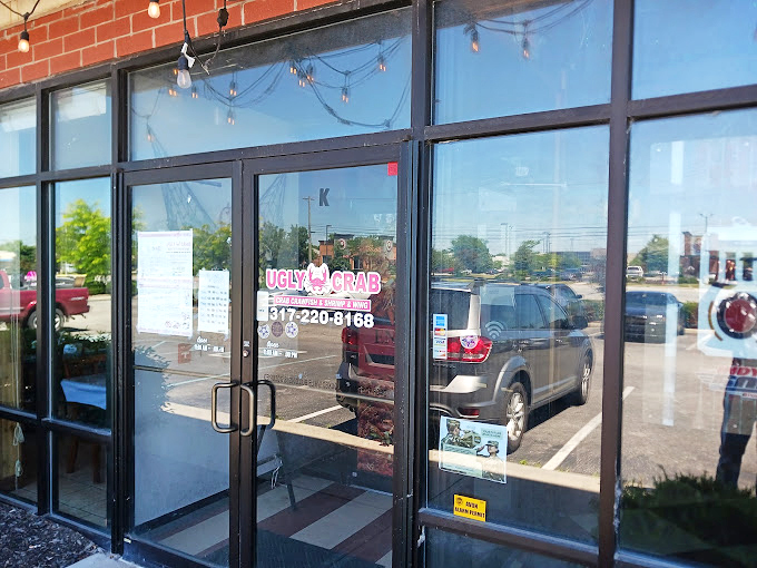 The entrance beckons with promises of seafood delights, standing proudly between Thai cuisine and suburban parking spaces.