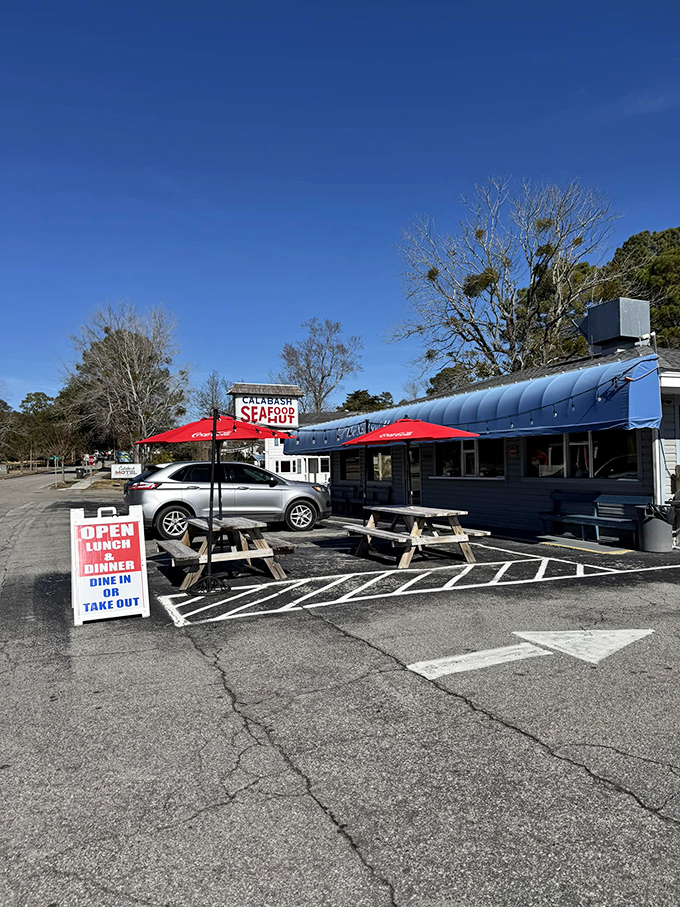 Where seafood dreams come true under Carolina blue skies, with picnic tables that have hosted more happy meals than any fast food chain.