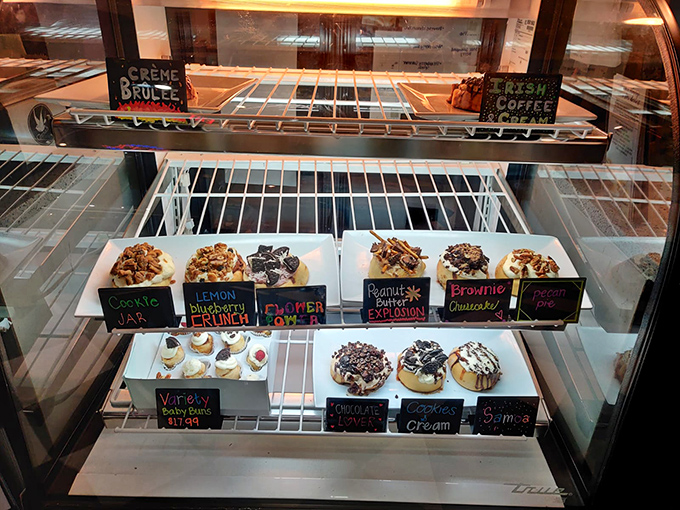 The display case: nature's most perfect habitat for observing cinnamon rolls in their final, glorious form before migration to your mouth.