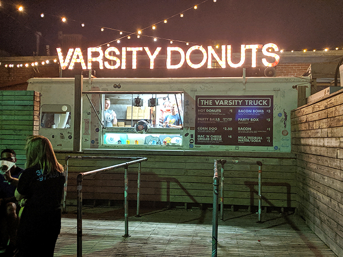 As darkness falls, the Varsity Truck emerges like a mint-green oasis of late-night cravings. College memories are made here.