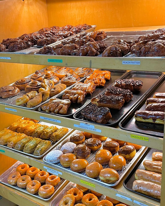 Fritters and twists and long johns, oh my! A golden-hued wonderland that makes breakfast feel like a celebration.