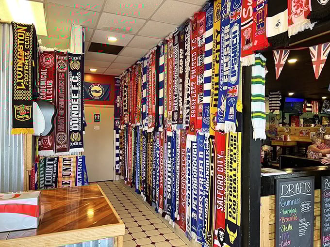 Football scarves create a textile tapestry of team loyalty, transforming a simple wall into a shrine to the beautiful game.