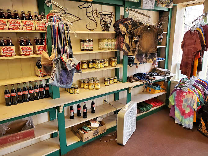 Nostalgic bottles line the shelves like sugary sentinels, Coca-Cola and preserves standing watch over your childhood memories.