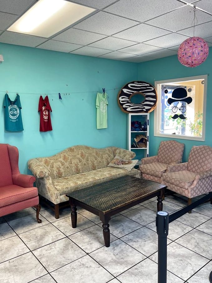 The lounge area features mismatched vintage furniture and a giant donut on the wall&mdash;because normal d&eacute;cor is for places that don't serve happiness by the dozen.