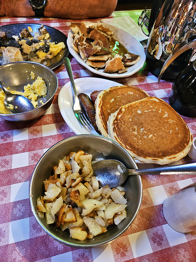 Breakfast battlefield: pancakes flanked by sausage soldiers, potato reinforcements standing by. The only appropriate strategy here is total consumption.