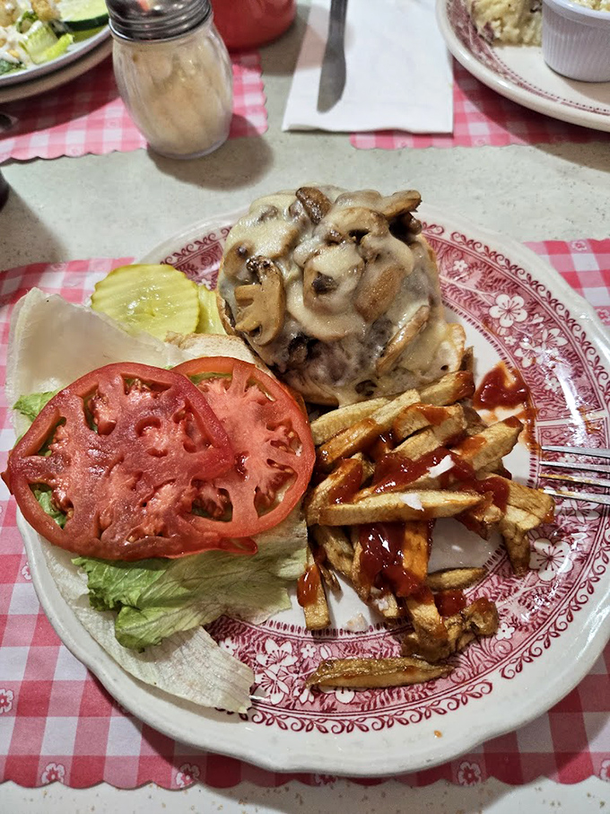 A burger that's having a meaningful relationship with mushrooms and Swiss cheese. Those hand-cut fries on the side aren't just a garnish&mdash;they're co-stars.
