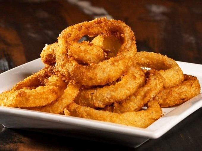 Onion rings so perfectly golden and crisp, they make you wonder if there's an onion ring whisperer back in the kitchen.