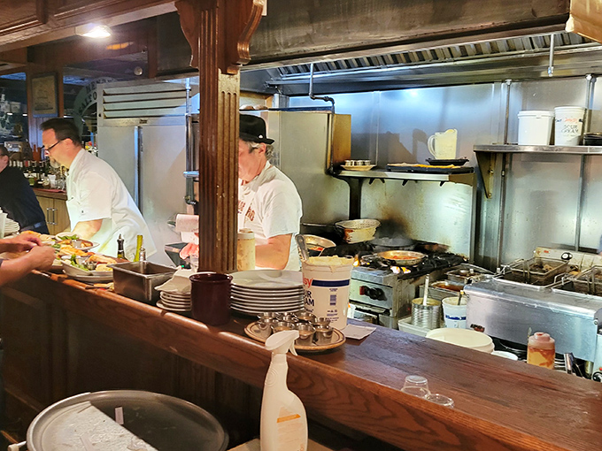 The open kitchen offers dinner and a show. These culinary captains navigate flames and pans with the confidence of sailors who've weathered many storms