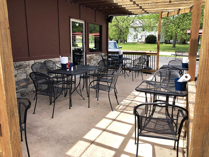 The outdoor seating area offers a shaded retreat for those pleasant Kansas days when eating inside feels like missing out on sunshine.