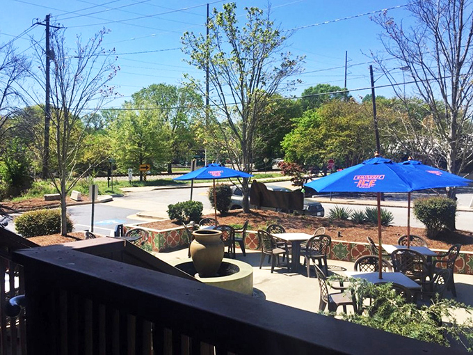 Outdoor seating that captures that perfect Georgia afternoon vibe. Blue umbrellas stand guard against the sun while conversations and margaritas flow freely.