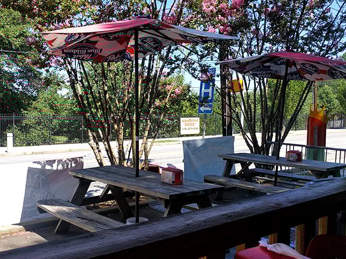 Outdoor seating under flowering trees&mdash;because sometimes you need nature to witness your moment of cheesesteak ecstasy.