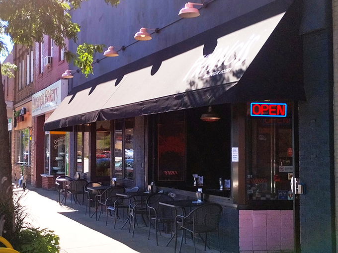 Sidewalk seating under pink-accented lights&mdash;because sometimes burgers taste even better with a side of people-watching.