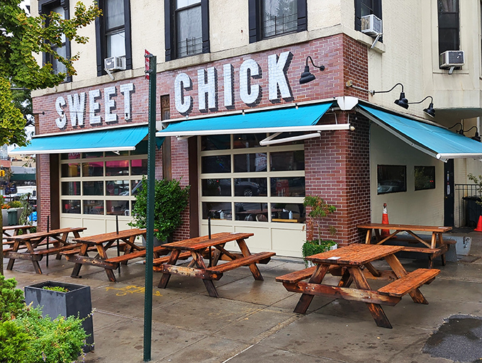 Blue awnings and wooden picnic tables create a sidewalk oasis where summer breezes accompany every bite of Southern-inspired Brooklyn fare.