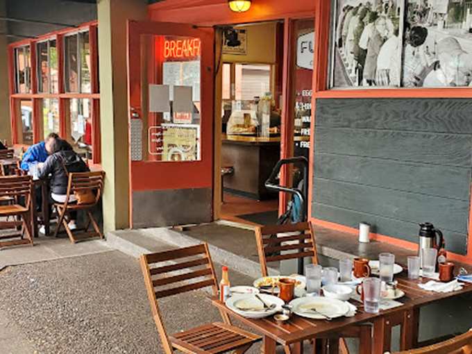 Morning sunshine filters through the windows, highlighting the simple joy of a meal shared at wooden tables outside.