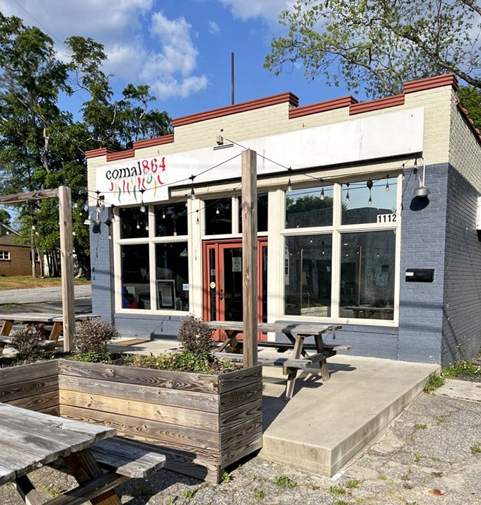 Spring sunshine bathes the patio in golden light, making those picnic tables the most coveted seats in Greenville when the weather cooperates.