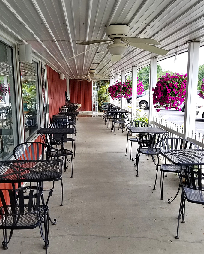 The porch seating area offers a front-row view to Indiana seasons, with hanging baskets providing a splash of color to complement your dessert.