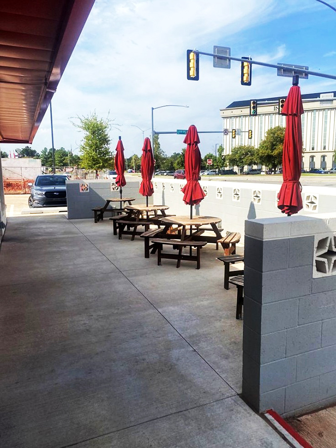 The outdoor patio with red umbrellas offers al fresco dining where you can enjoy your eggs while contemplating life's big questions, like "Should I order seconds?"