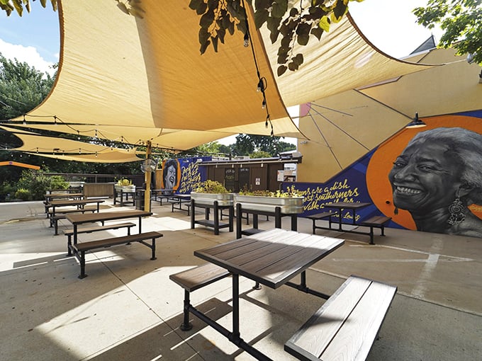 The outdoor patio offers a moment of Asheville zen&mdash;where shade sails dance overhead and local art reminds you exactly where you are.