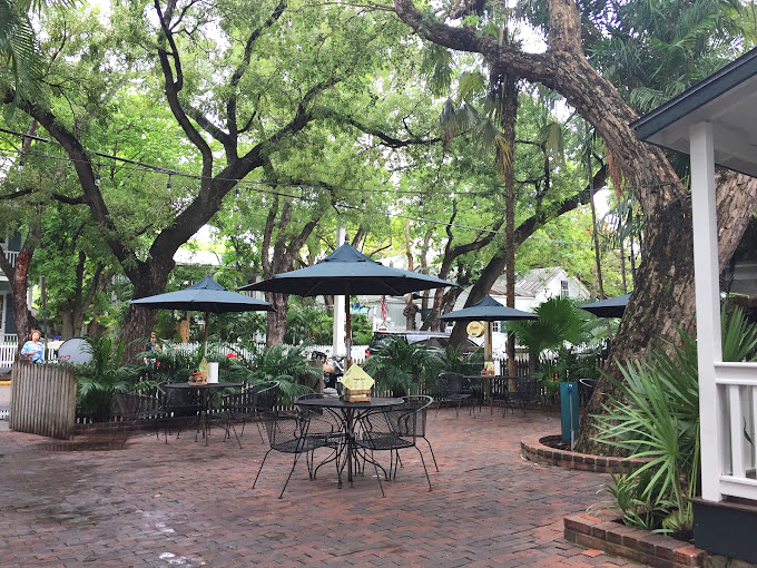 The patio's lush greenery creates a secret garden vibe &ndash; the perfect backdrop for the serious business of enjoying every last bite.