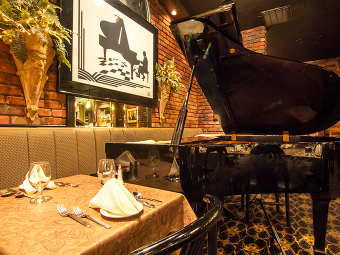 The baby grand piano isn't just decoration - it's a promise that some evenings here transcend mere dining to become full experiences.