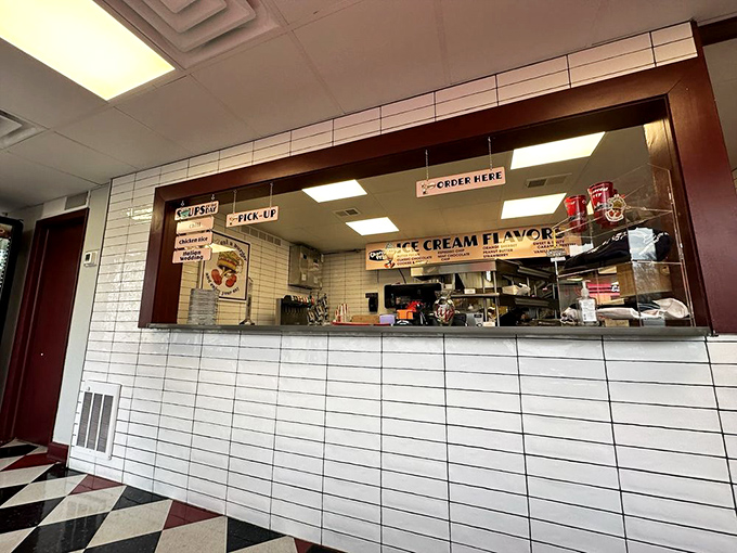 Behind this order window, kitchen magicians transform simple ingredients into legendary meals, like watching Carnegie Hall performances through a peephole.