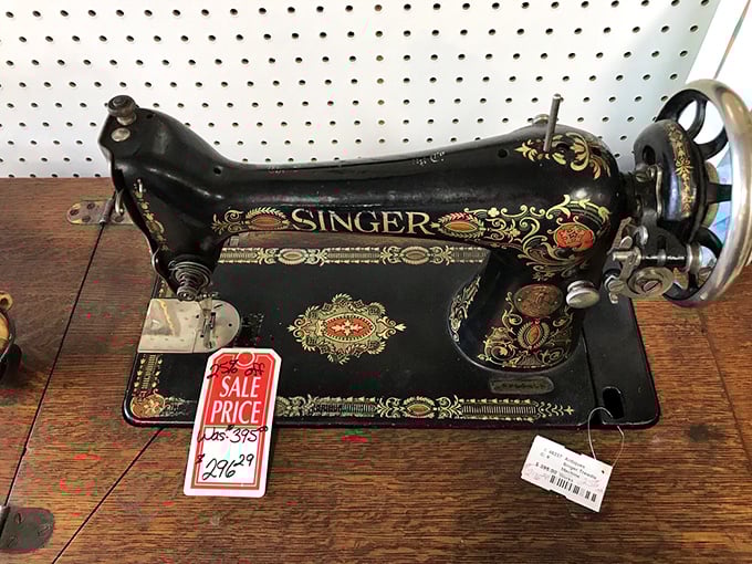 A Singer sewing machine sits proudly, its ornate decoration reminding us when even everyday tools were designed with beauty in mind.