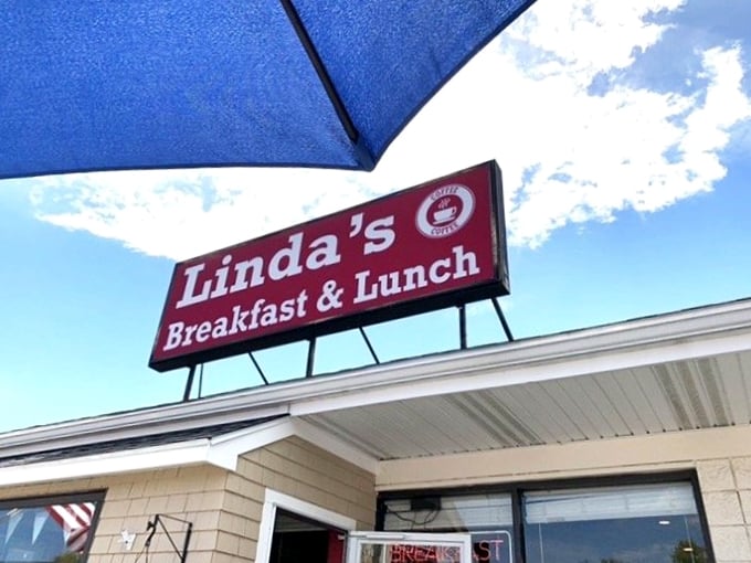 The sign calls to hungry travelers like a breakfast lighthouse, guiding morning-starved sailors safely to shore with promises of coffee and pancakes.