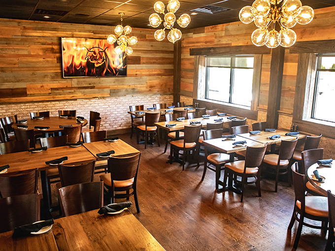 Tables set with military precision under artistic lighting – this dining room is dressed for success and ready to impress.