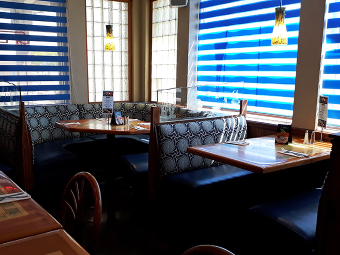 Cozy booths with patterned upholstery invite lingering conversations over multiple courses. Maritime comfort in the desert.