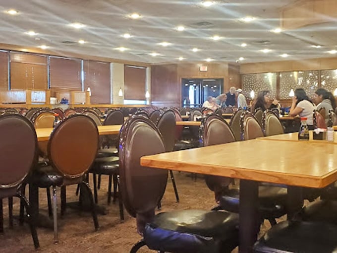 Tables await the next wave of hungry explorers, each chair having witnessed countless buffet strategies, triumphs, and food comas.