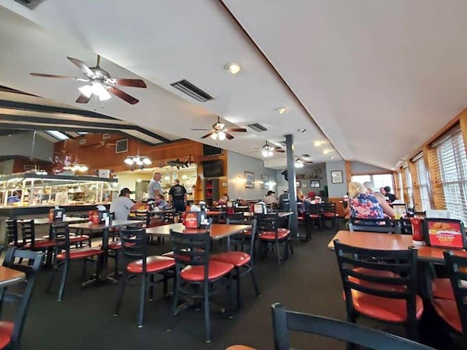 Red chairs pop against dark tables in a dining room designed for lingering conversations and the inevitable "just one more plate" decision.