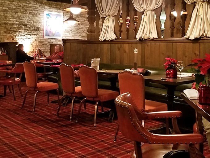 Red chairs against plaid carpet create that perfect "fancy but comfortable" vibe. Like wearing your best outfit with your comfiest shoes.