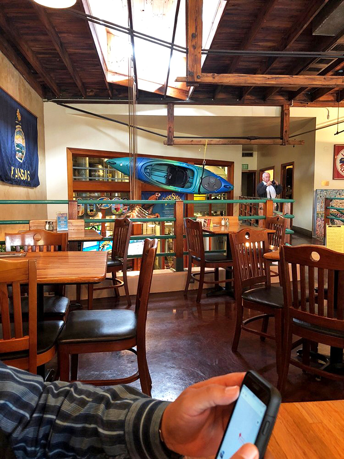 Upstairs seating with a kayak on display&mdash;because nothing says "Kansas" quite like unexpected nautical decor in a landlocked state.