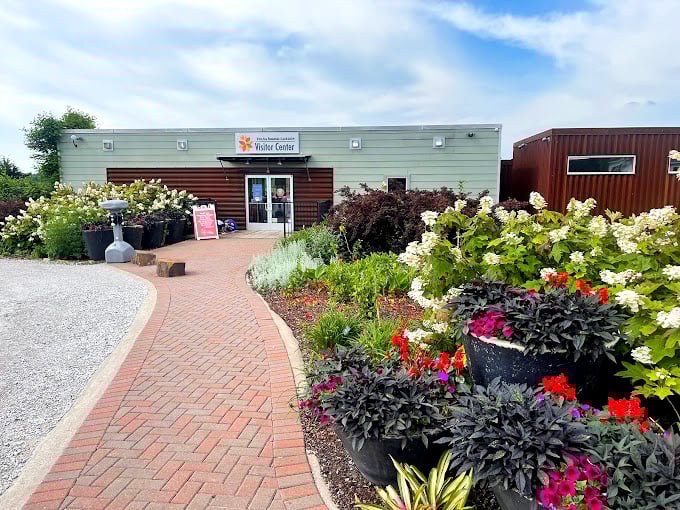 The visitor center welcomes garden enthusiasts with a brick path that practically begs you to follow it into a world of botanical wonders.