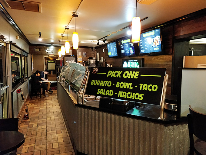 The modern dining experience: illuminated menus, industrial-chic design, and the promise of customization that makes everyone feel like a culinary director.