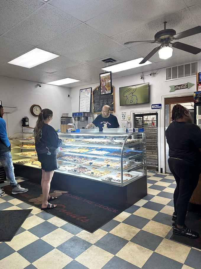 Late night at Old Town Donuts – where the illuminated yellow hand beckons night owls and early birds alike to sugary salvation.