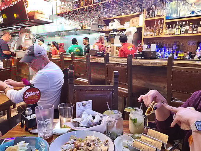 The open kitchen reveals the choreography behind your meal. Those aren't just cooks&mdash;they're conductors of a delicious symphony.