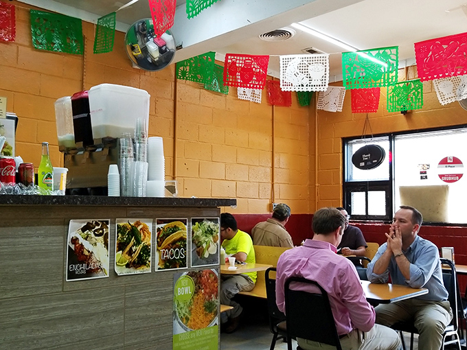 The colorful papel picado flags overhead aren't just decoration&mdash;they're celebration banners for the flavor party happening at every table.