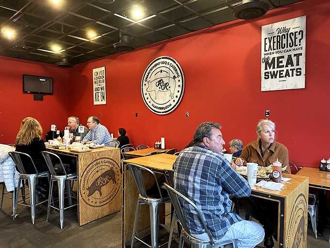 The universal language of barbecue brings strangers together in a red-walled sanctuary where conversation stops only for chewing.