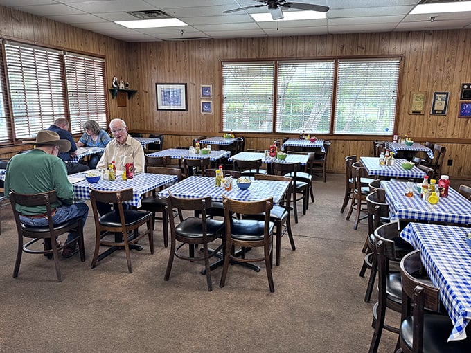 The dining room hums with the quiet satisfaction of locals who know they're in on America's best-kept fried chicken secret.