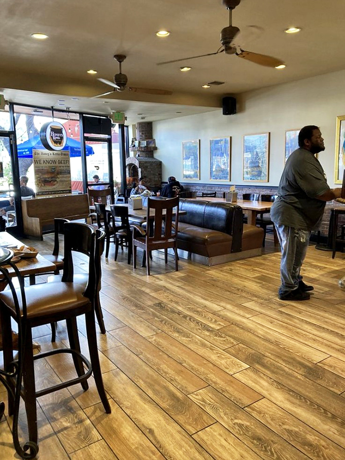 The warm wood floors and leather booths create a space where strangers become friends, united by their mutual love of perfect fried chicken.