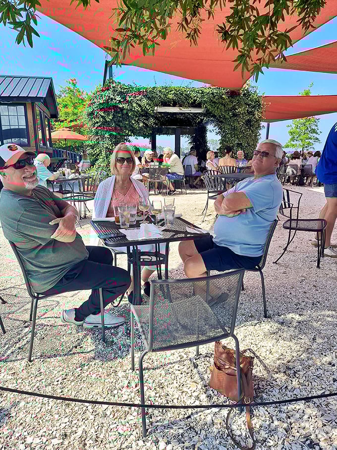 Happy diners under coral canopies&mdash;proof that the best seasoning for seafood is good company and Rappahannock River views.