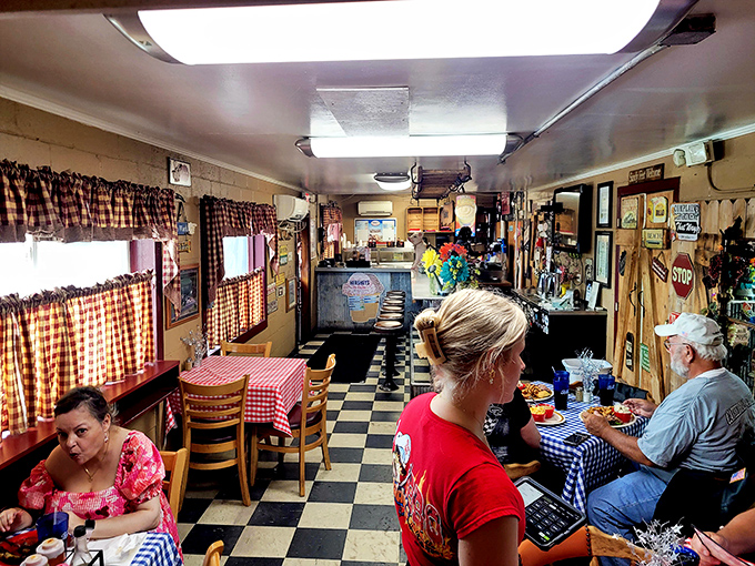 Happiness is a full diner! The checkered tablecloths and satisfied customers paint a picture of barbecue bliss.