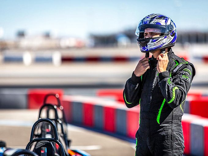 Suiting up for battle. That focused look says, "I'm about to set a lap record," or possibly, "I hope I remember which pedal is the brake."