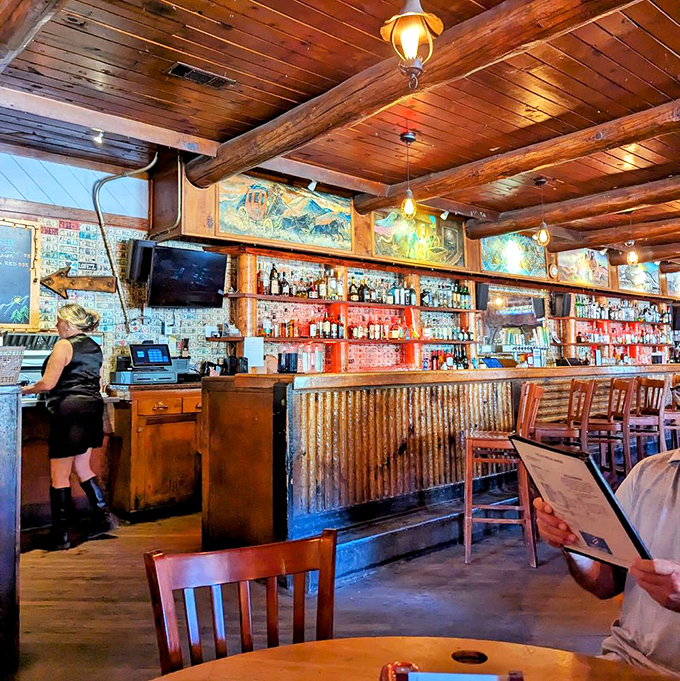 The bar&mdash;where liquid artistry meets rustic charm. Those colorful murals and well-stocked shelves promise adventures both in glass and on plate.