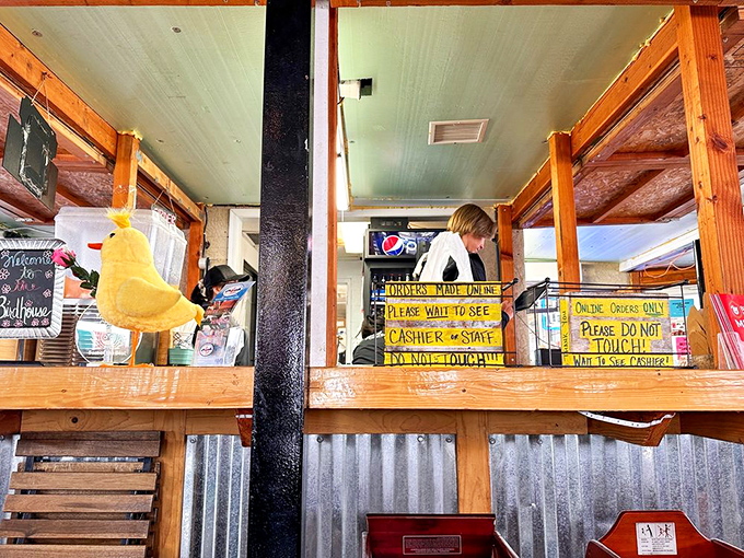 Handwritten signs add charm to the ordering counter, where chicken dreams begin their journey to delicious reality.