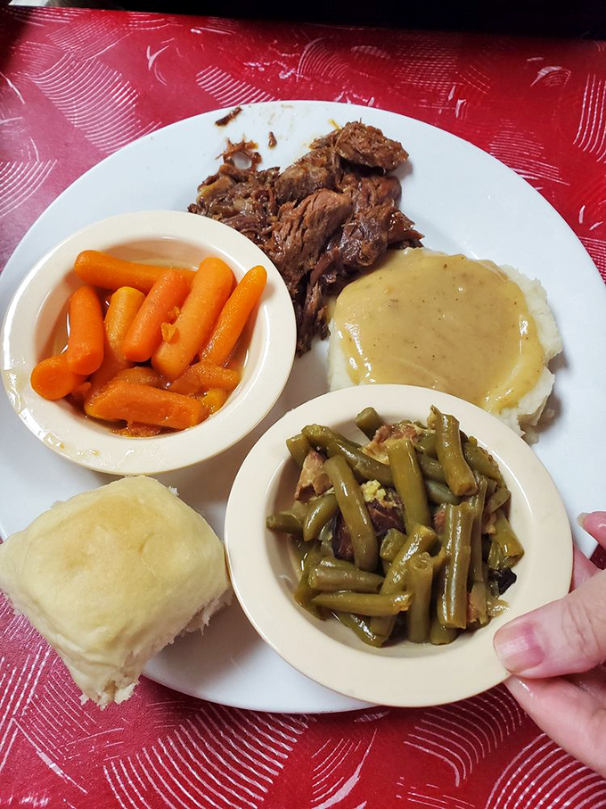 A plate that honors the holy trinity of comfort: savory roast beef, green beans cooked with purpose, and carrots that have known real butter.