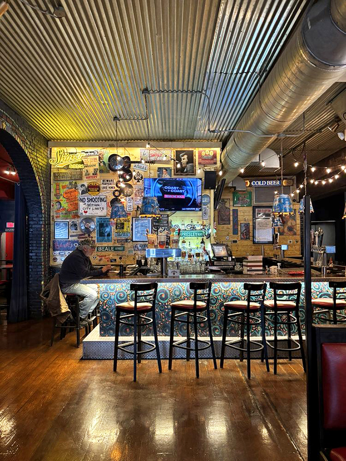 The bar wall tells stories through vintage signs and memorabilia. It's like drinking in a museum where the exhibits encourage revelry.