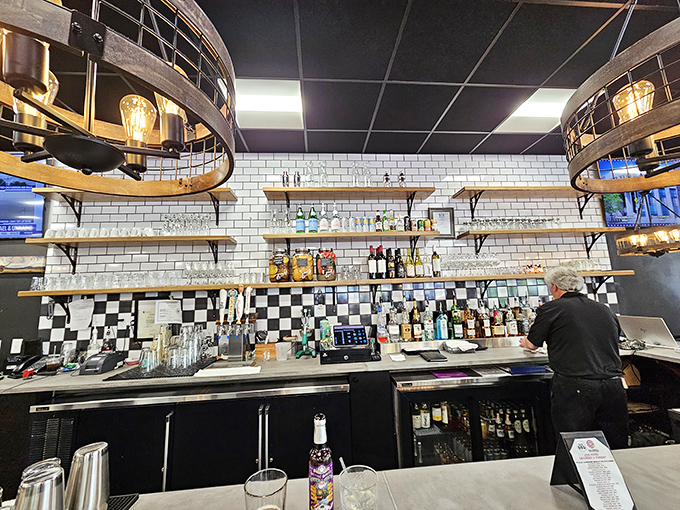 The bar area blends subway tiles and checkered patterns to create that rare space where morning mimosas feel like a responsible decision.